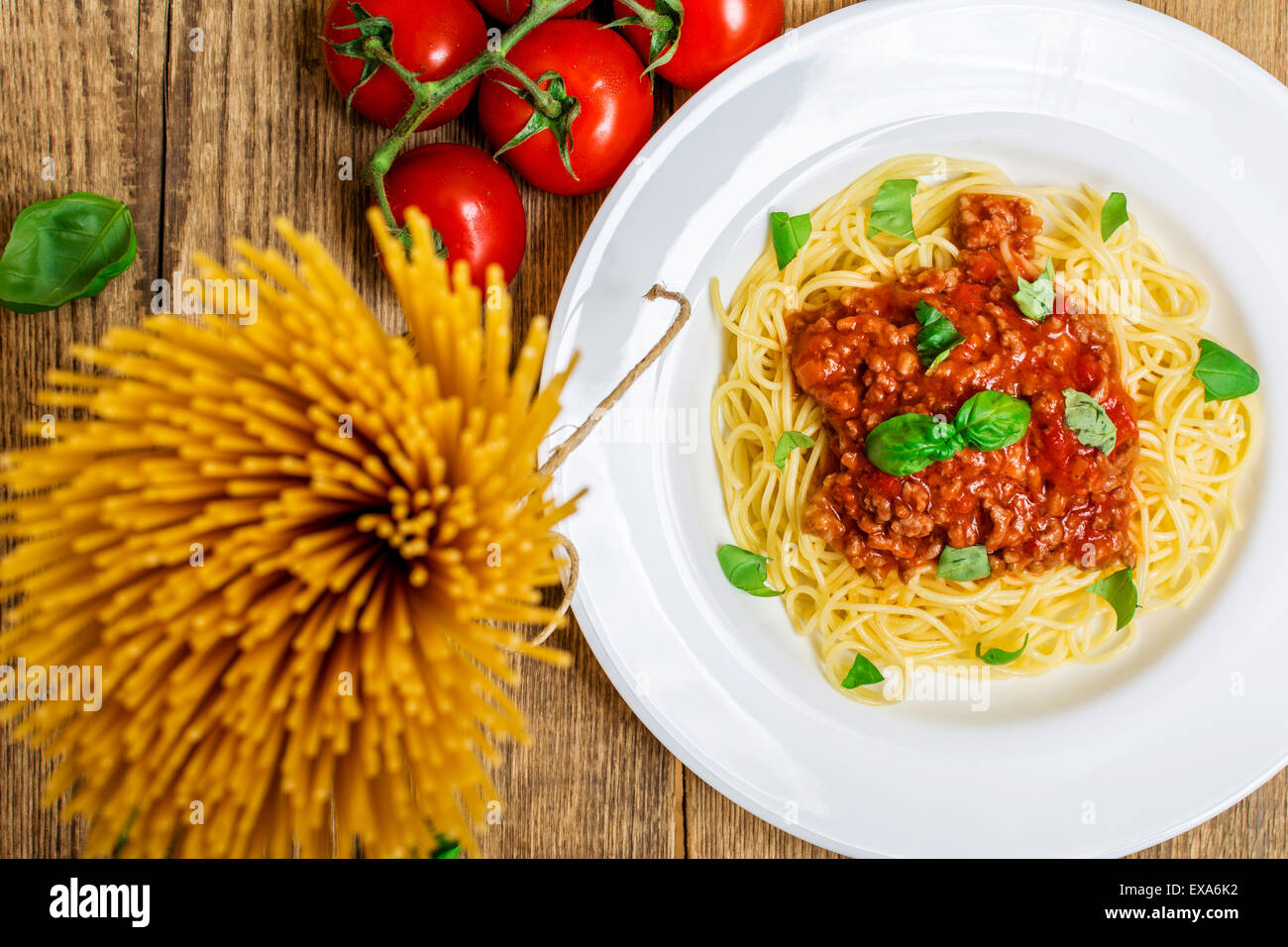 Spaghetti with bolognese sauce and basil on wood table Stock Photo - Alamy