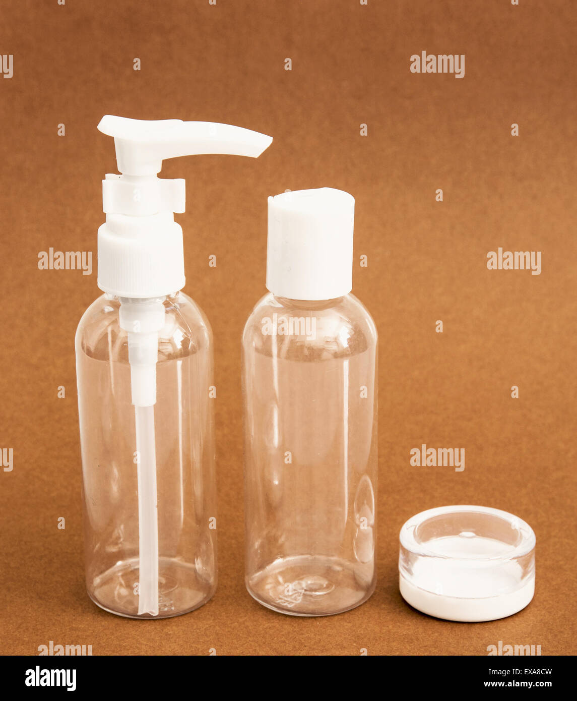 Empty travel cosmetics bottles on the brown background Stock Photo - Alamy