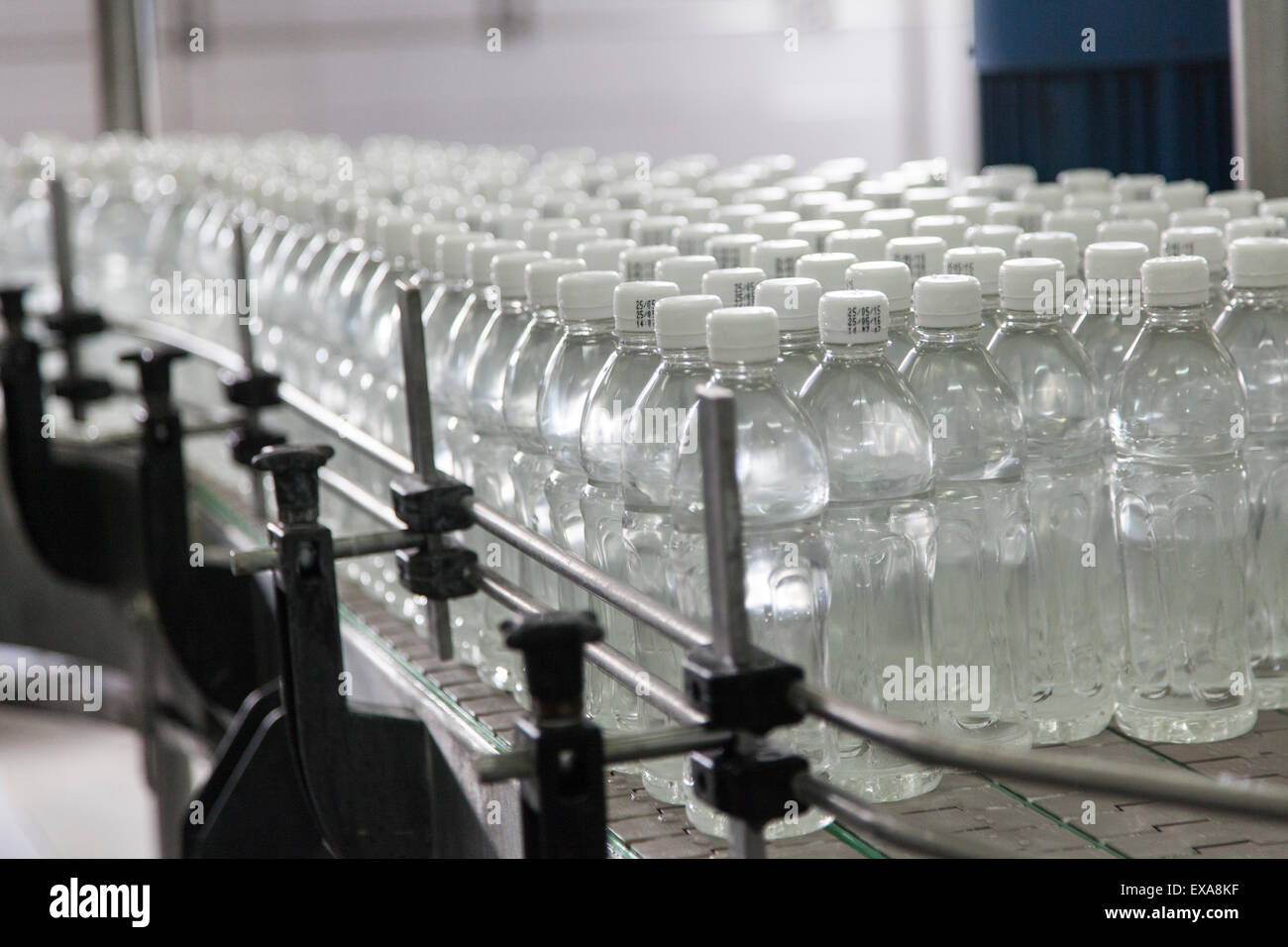 Bottle filled with water standing on the assembly line Stock Photo - Alamy