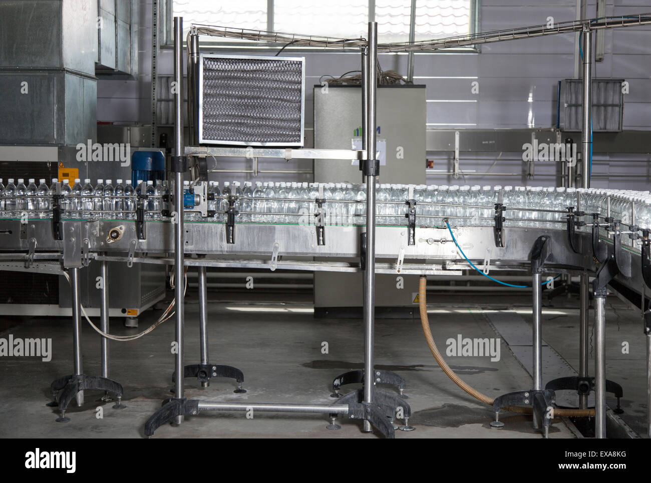Bottle filled with water standing on the assembly line Stock Photo - Alamy