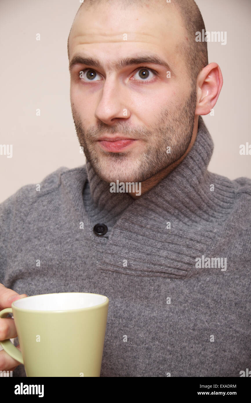 fashion portrait of handsome young man in a gray sweater isolated on ...