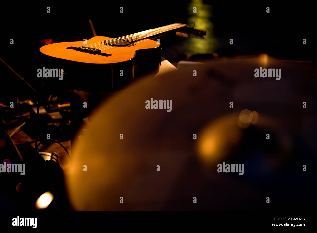 An accoustic guitar under stage lighting Stock Photo - Alamy