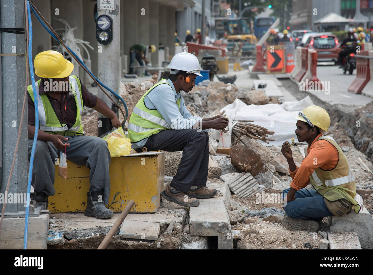 Migrant construction workers have a break at building site in Singapore ...