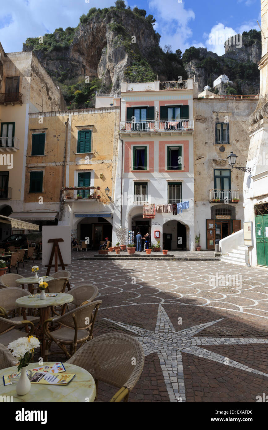 Town square with restaurant tables and colourful buildings, star shaped ...