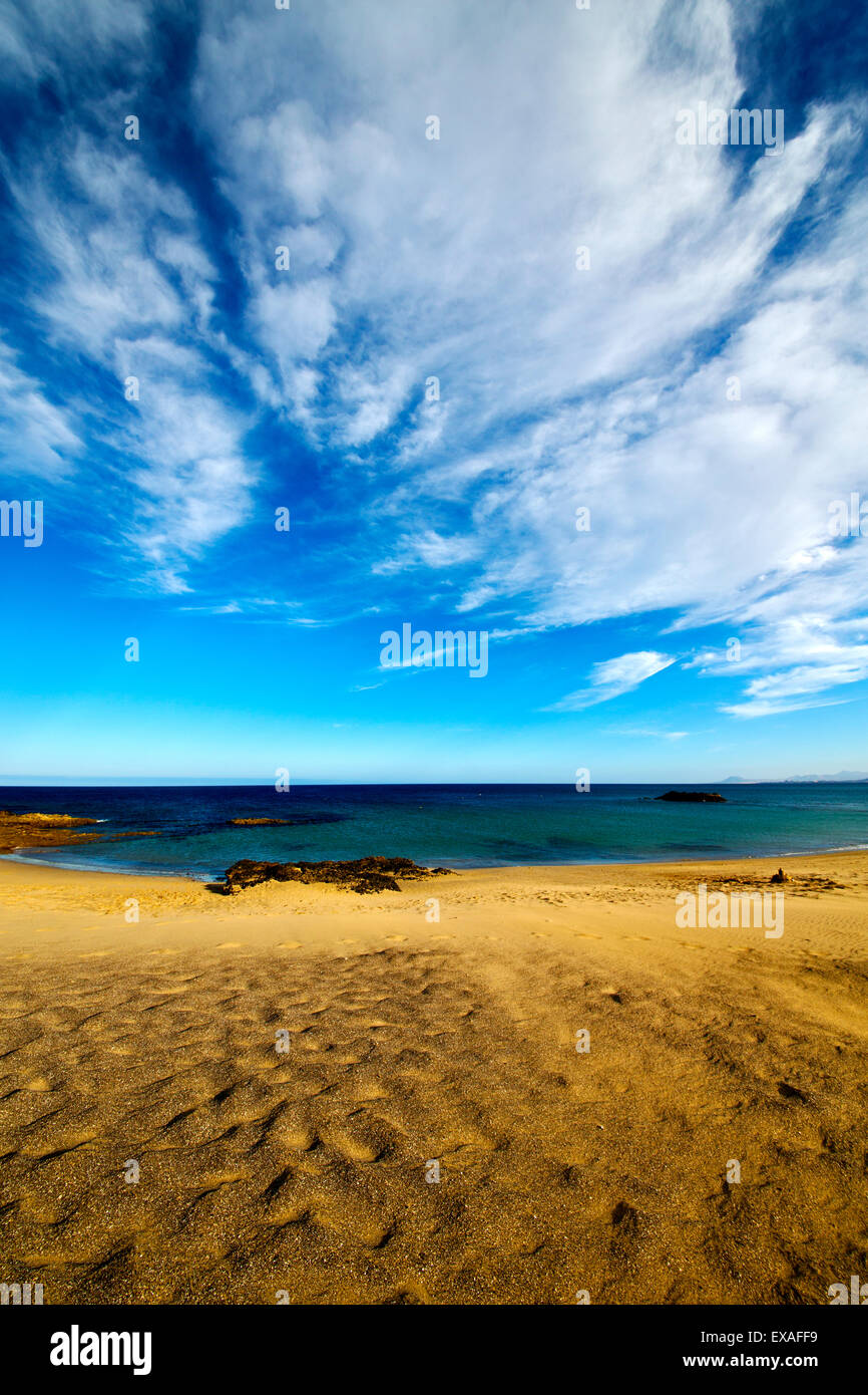footstep in lanzarote spain rock stone sky cloud beach water musk pond ...