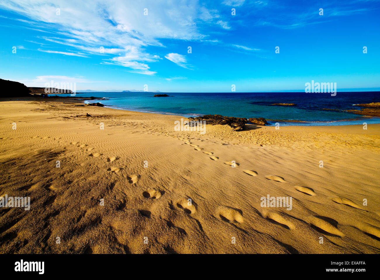 footstep in lanzarote spain rock stone sky cloud beach water musk pond ...