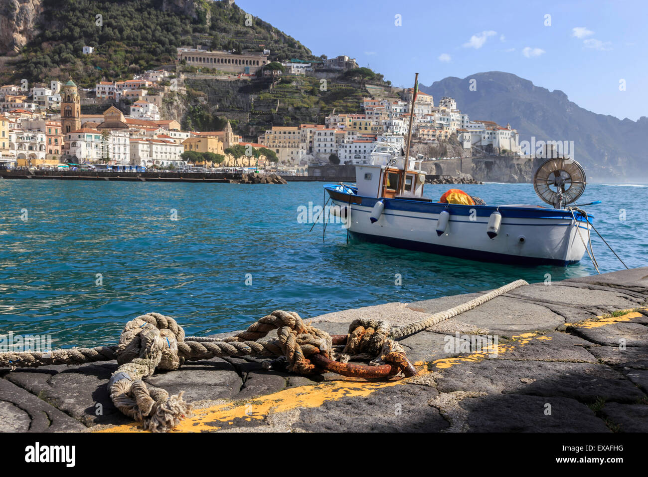 Tethered fishing boat, Amalfi harbour, from quayside with view towards ...
