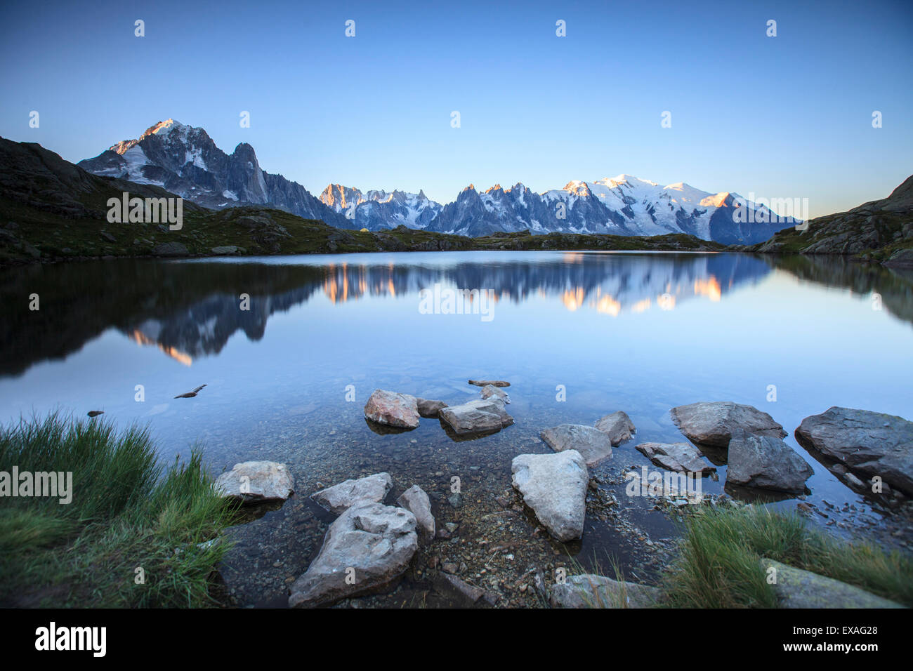 Mont Blanc range reflected at sunrise, shore of Lac des Cheserys ...