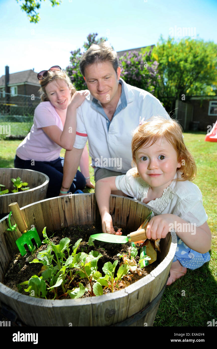 Family young daughter planting seeds hi-res stock photography and ...