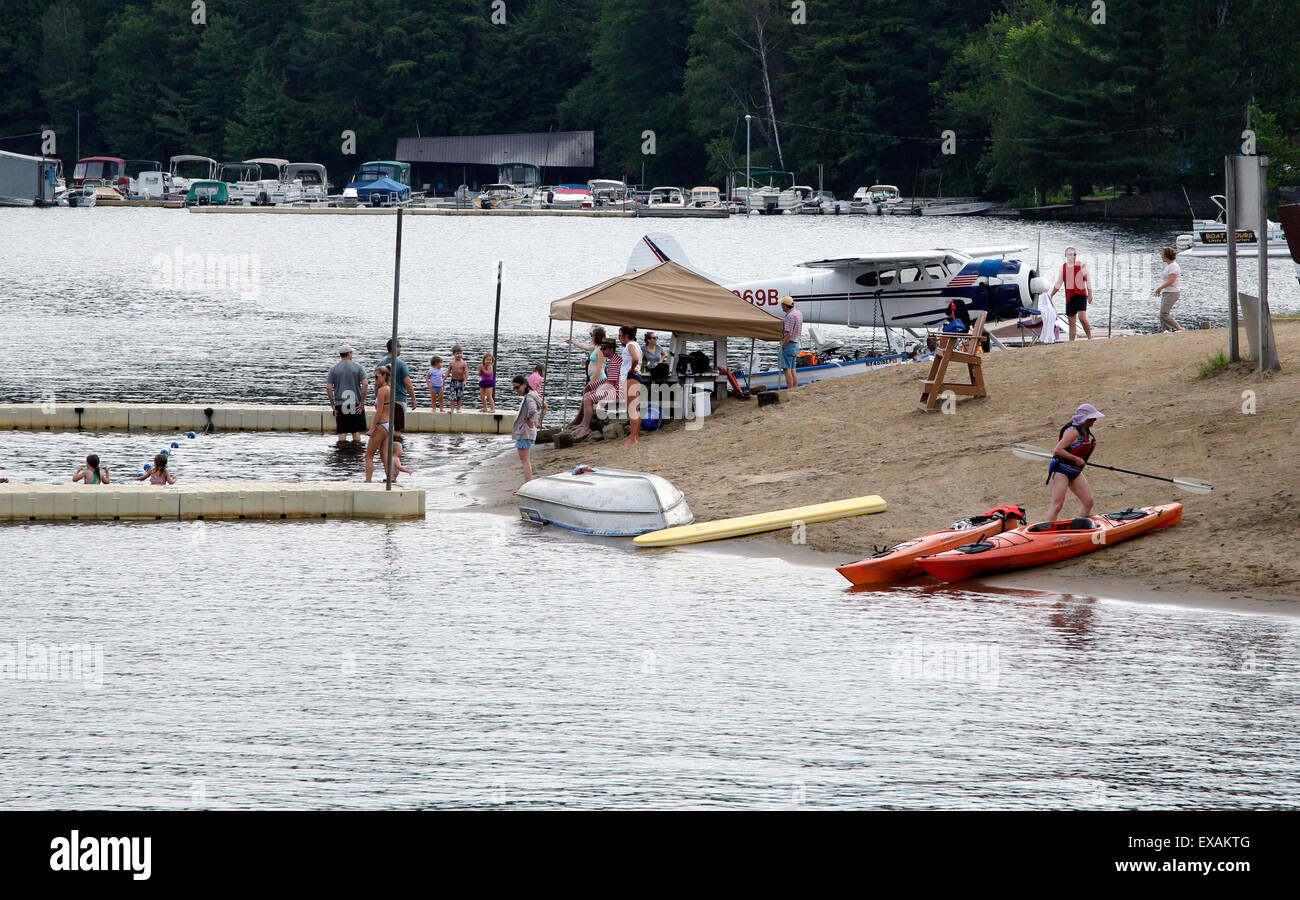 Public beach at Long Lake New York with bathers at Long Lake Adirondack ...