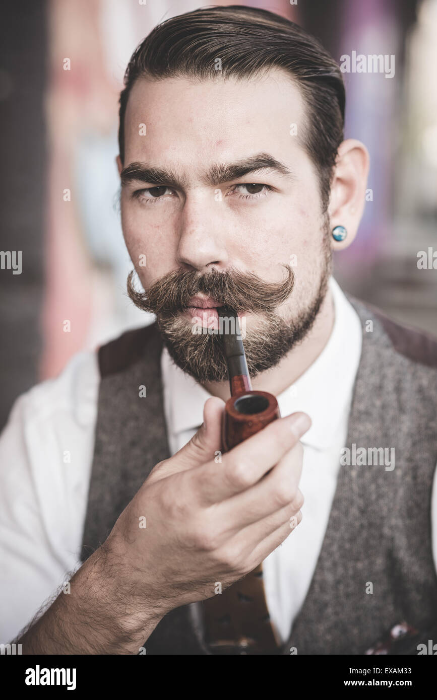 handsome big moustache hipster man smoking pipe in the city Stock Photo ...