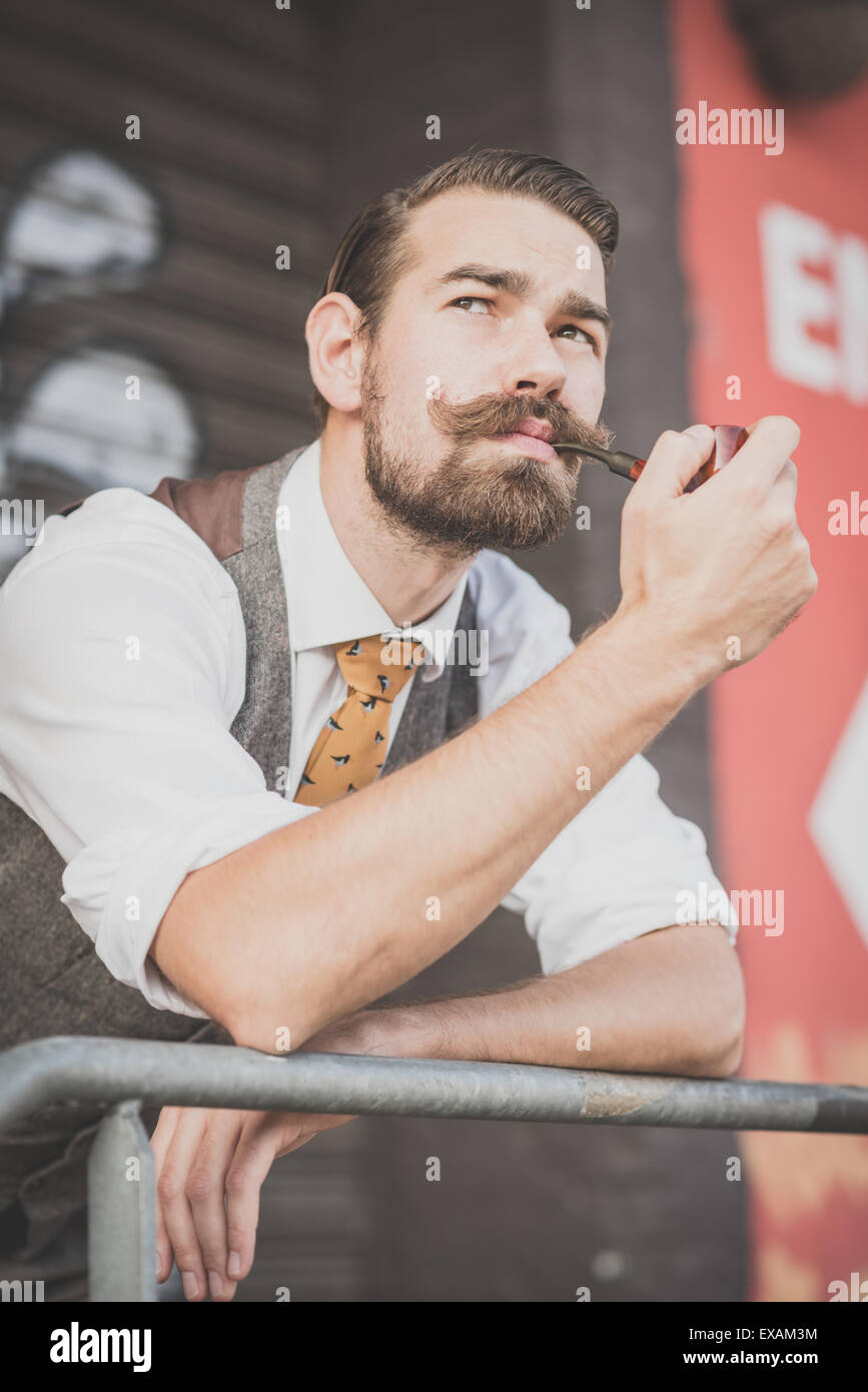 handsome big moustache hipster man smoking pipe in the city Stock Photo ...