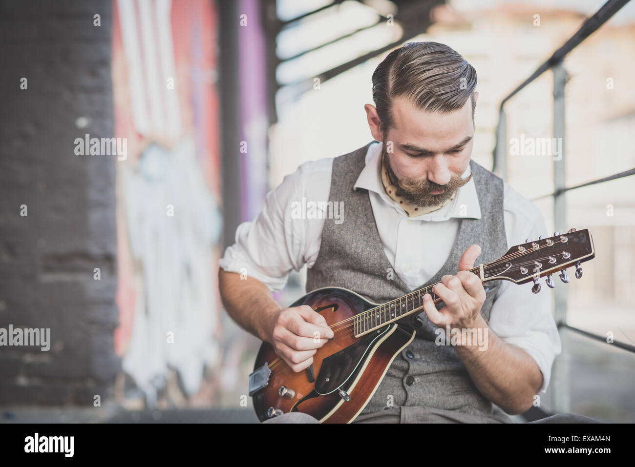 handsome big moustache hipster man playing mandolin in the city Stock ...