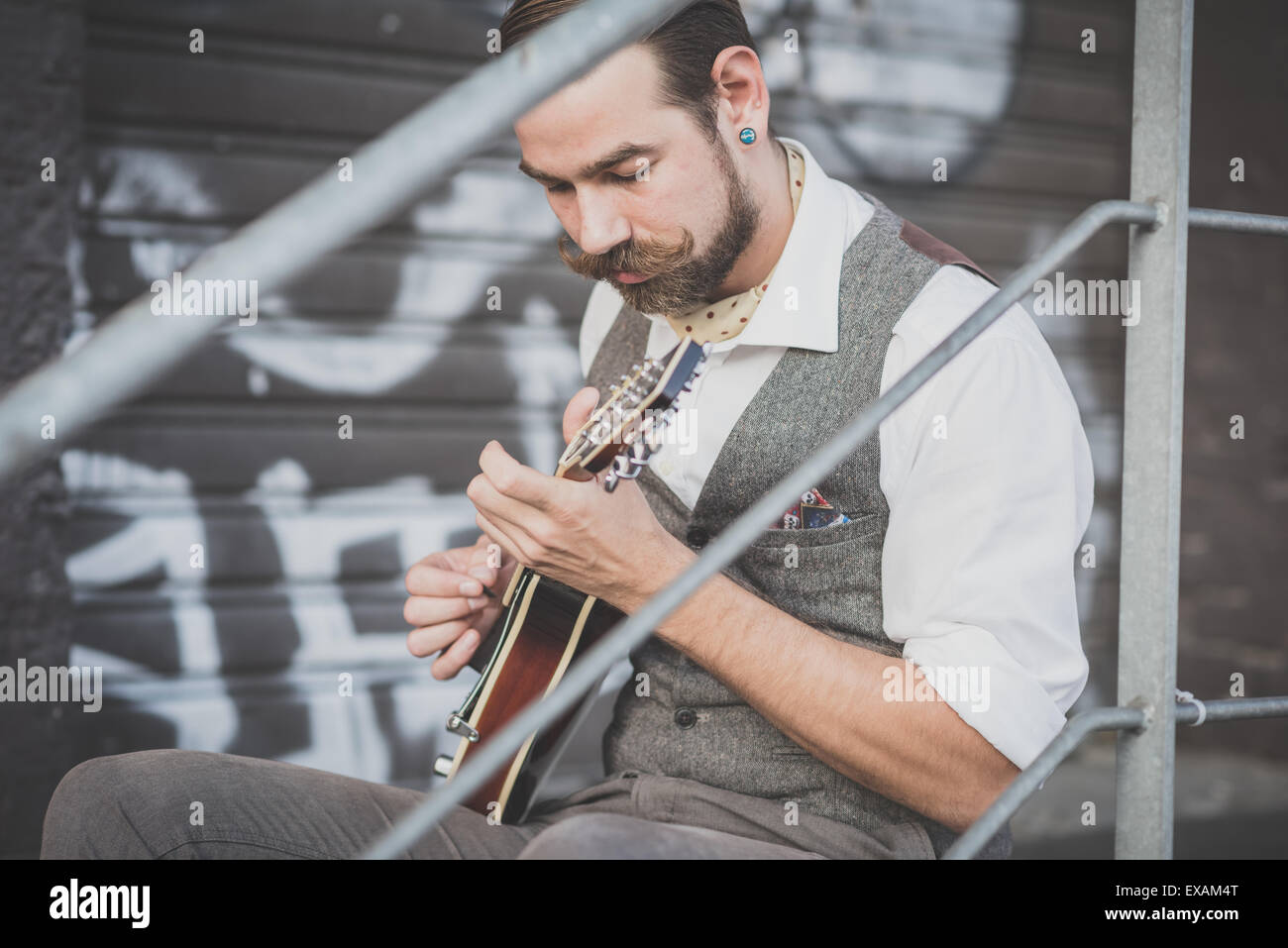 handsome big moustache hipster man playing mandolin in the city Stock ...