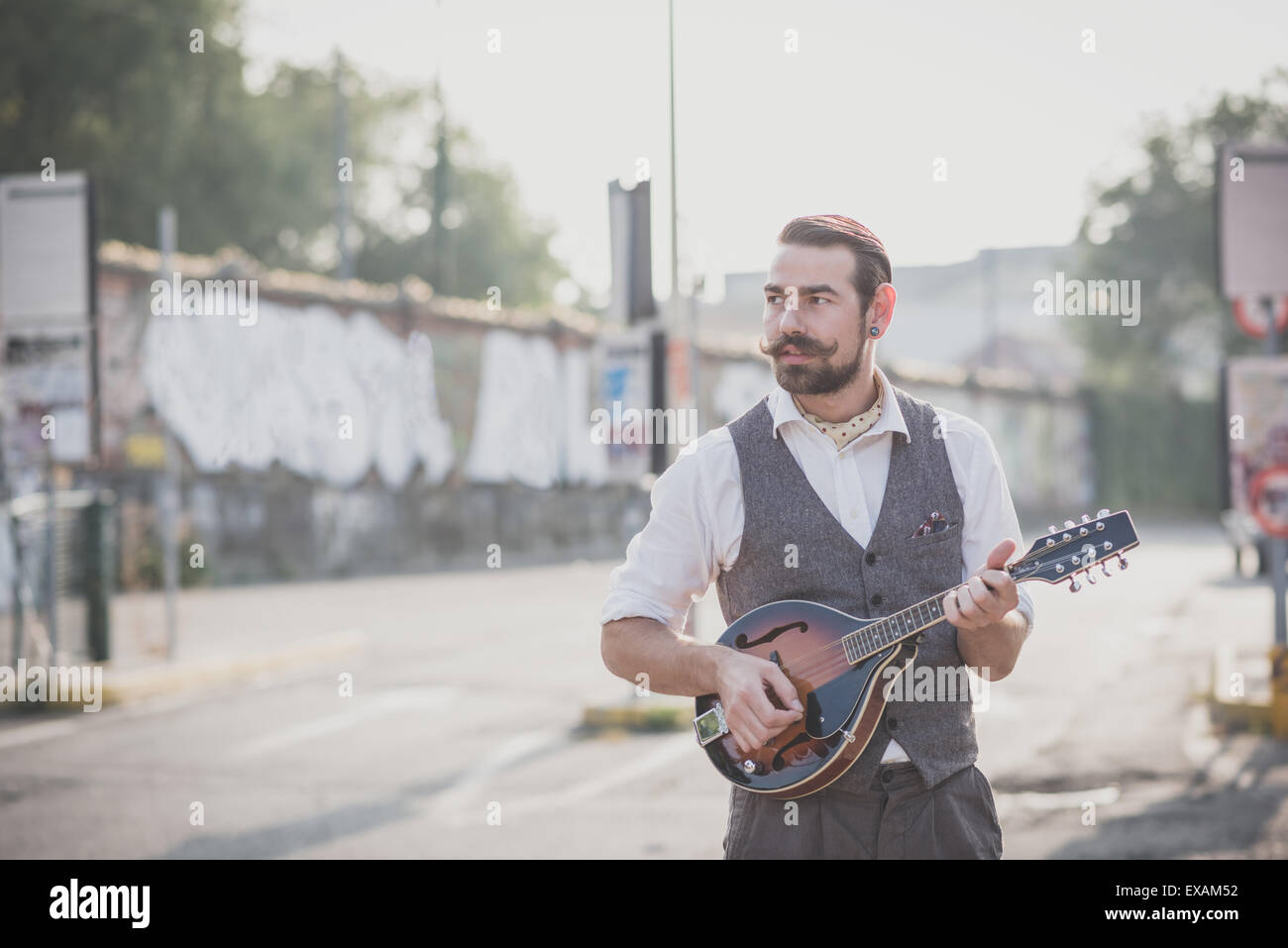 handsome big moustache hipster man playing mandolin in the city Stock ...