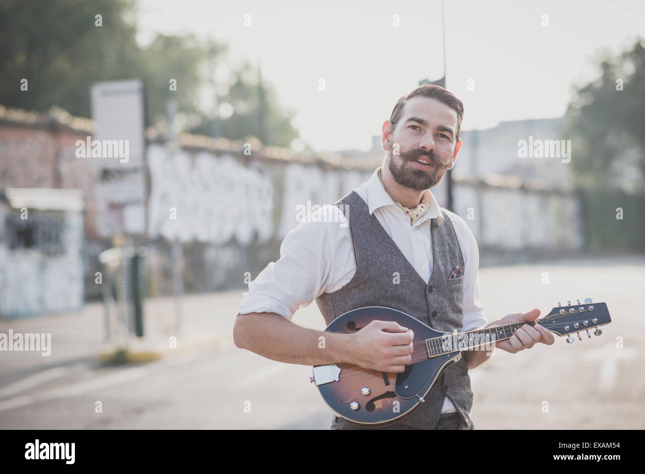 handsome big moustache hipster man playing mandolin in the city Stock ...