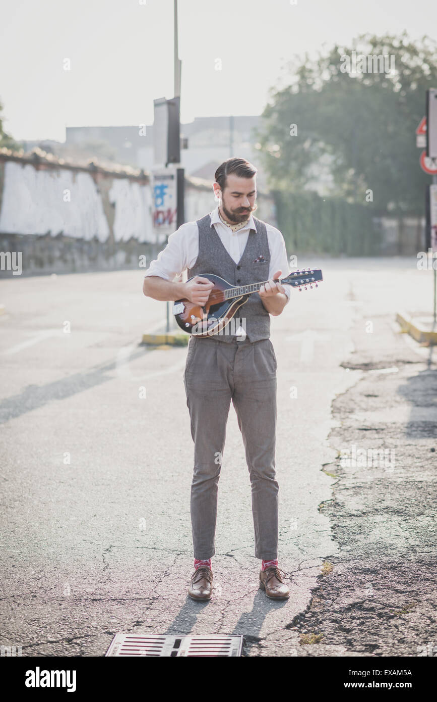 handsome big moustache hipster man playing mandolin in the city Stock ...