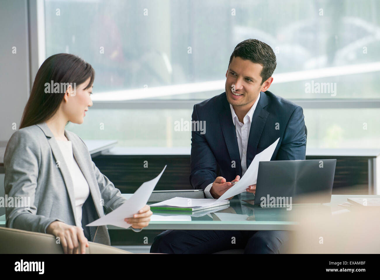 Business associates reviewing document Stock Photo - Alamy