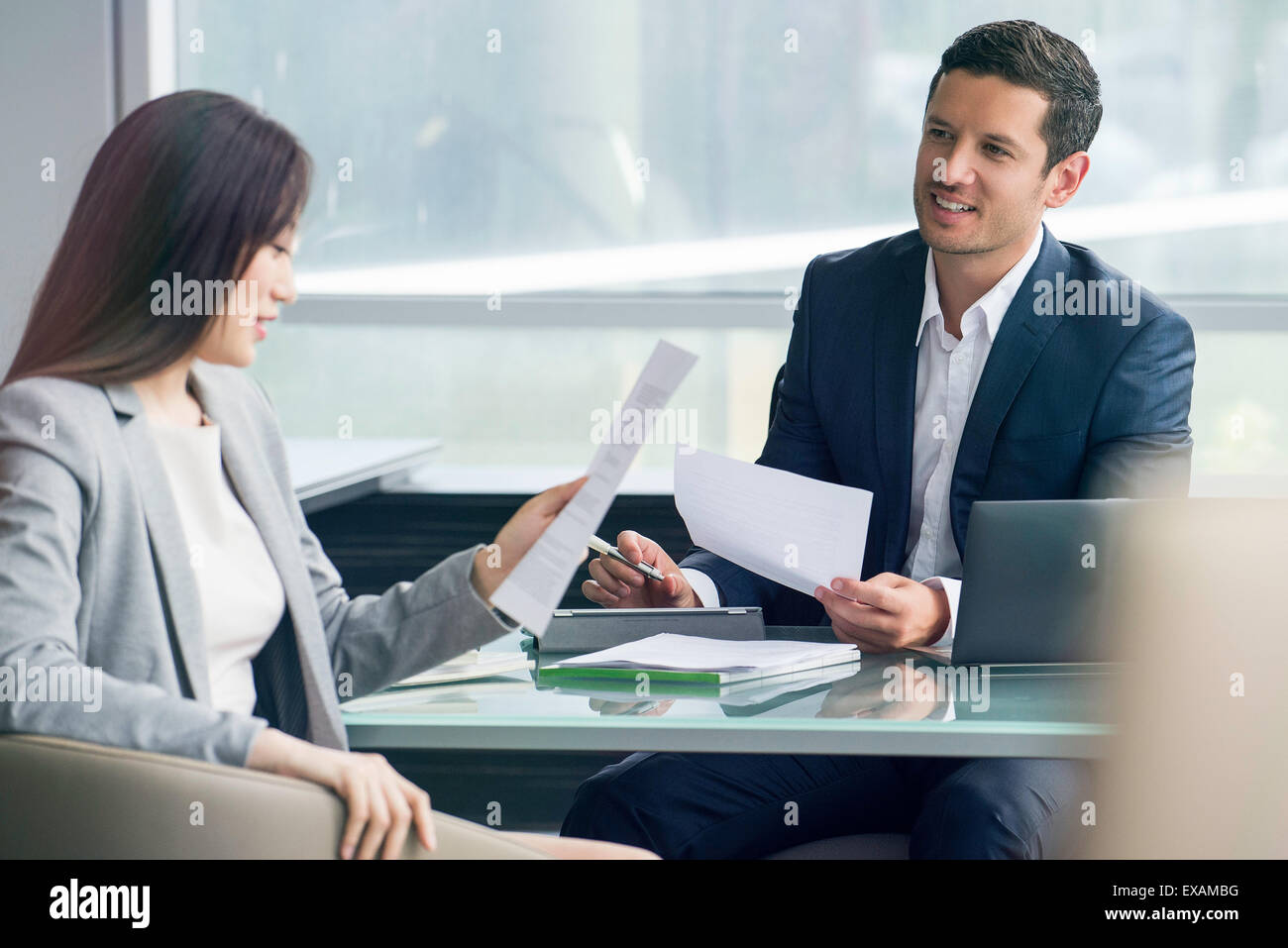 Business associates reviewing document Stock Photo - Alamy