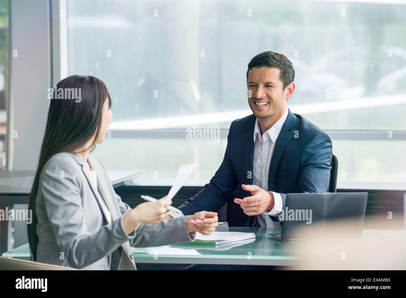 Lawyer reviewing document with client Stock Photo - Alamy