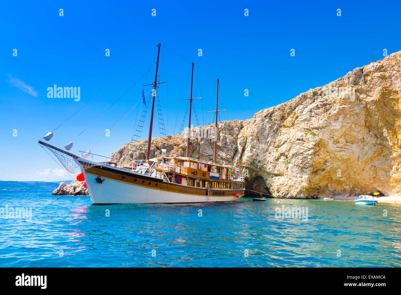 Vintage sailing boat in bay Stock Photo - Alamy