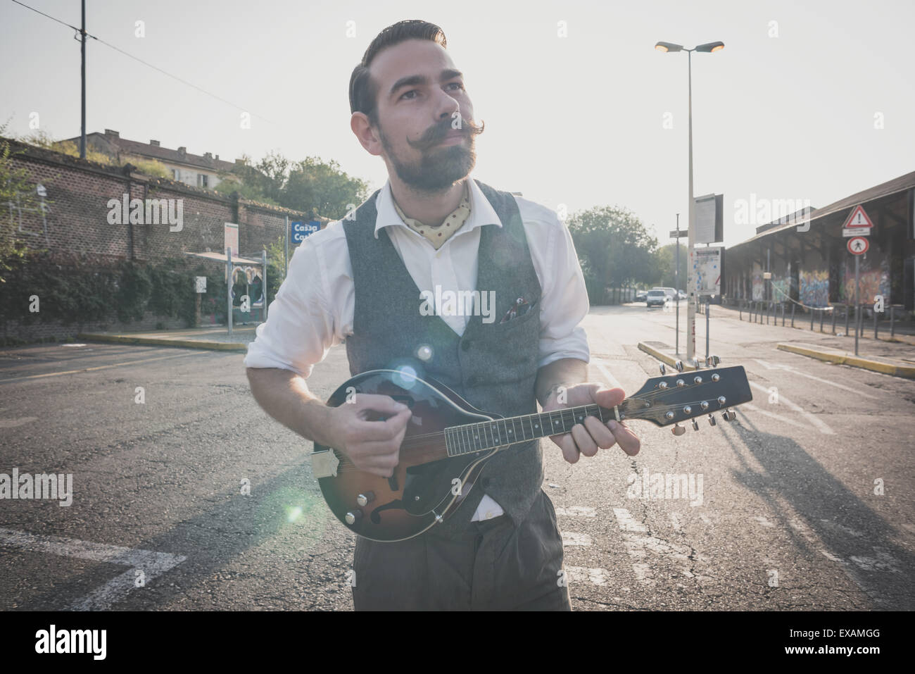 handsome big moustache hipster man playing mandolin in the city Stock ...