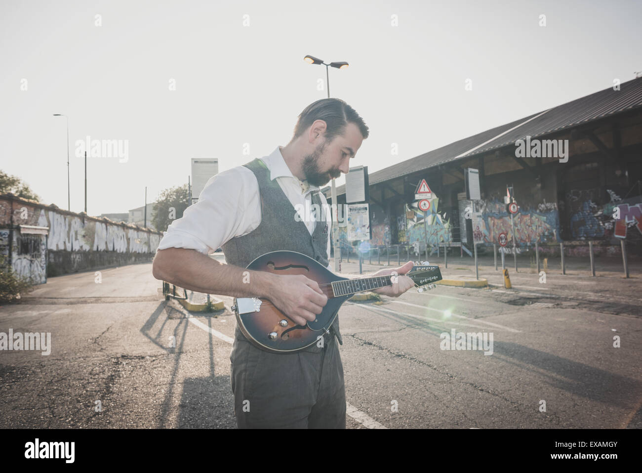 handsome big moustache hipster man playing mandolin in the city Stock ...