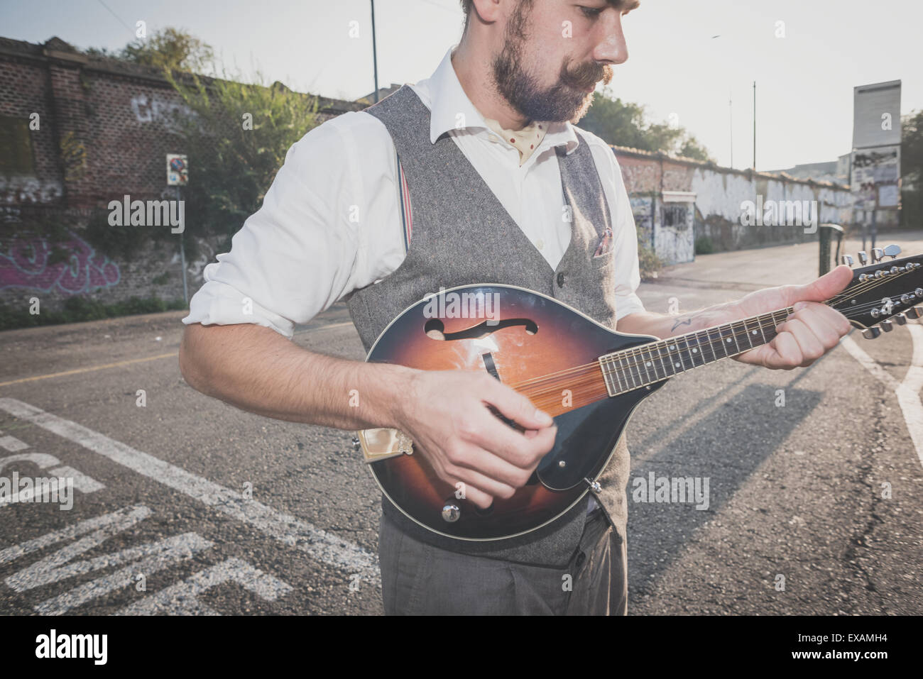 handsome big moustache hipster man playing mandolin in the city Stock ...