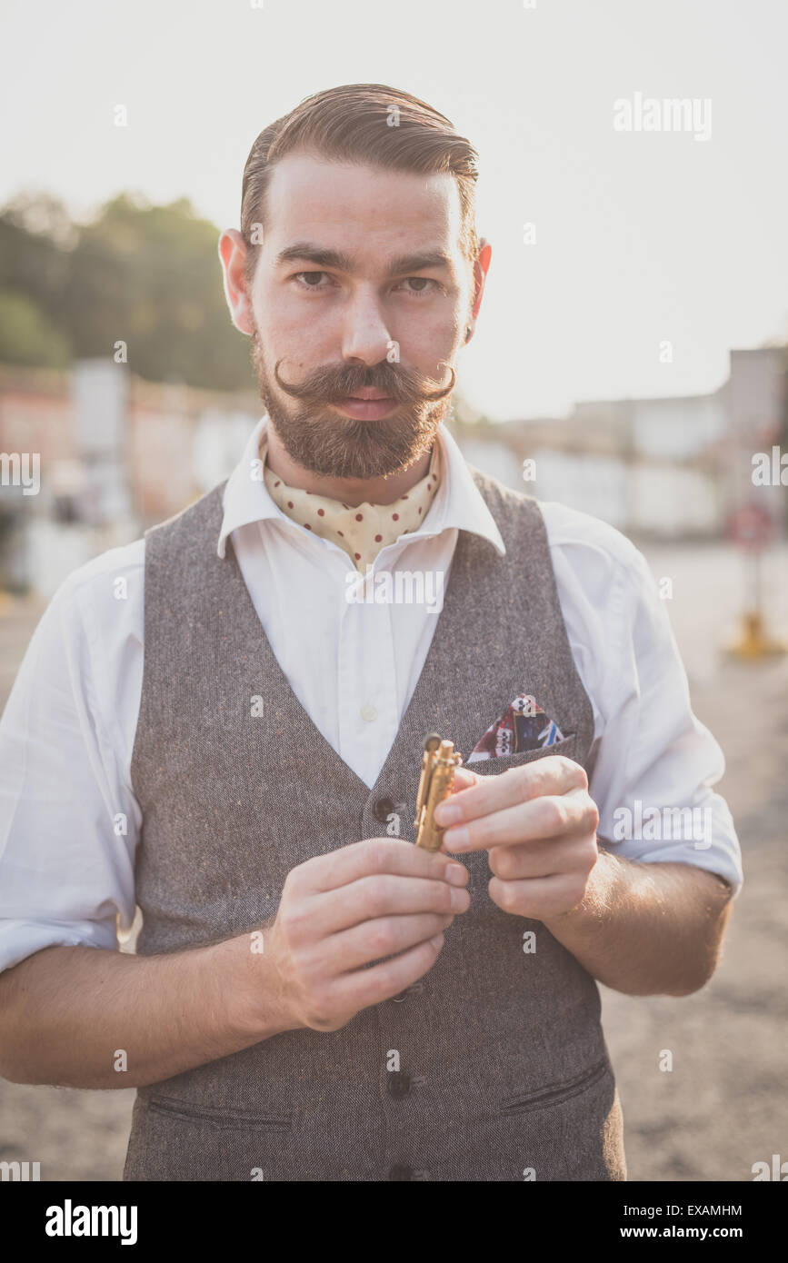 handsome big moustache hipster man smoking cigarette in the city Stock ...