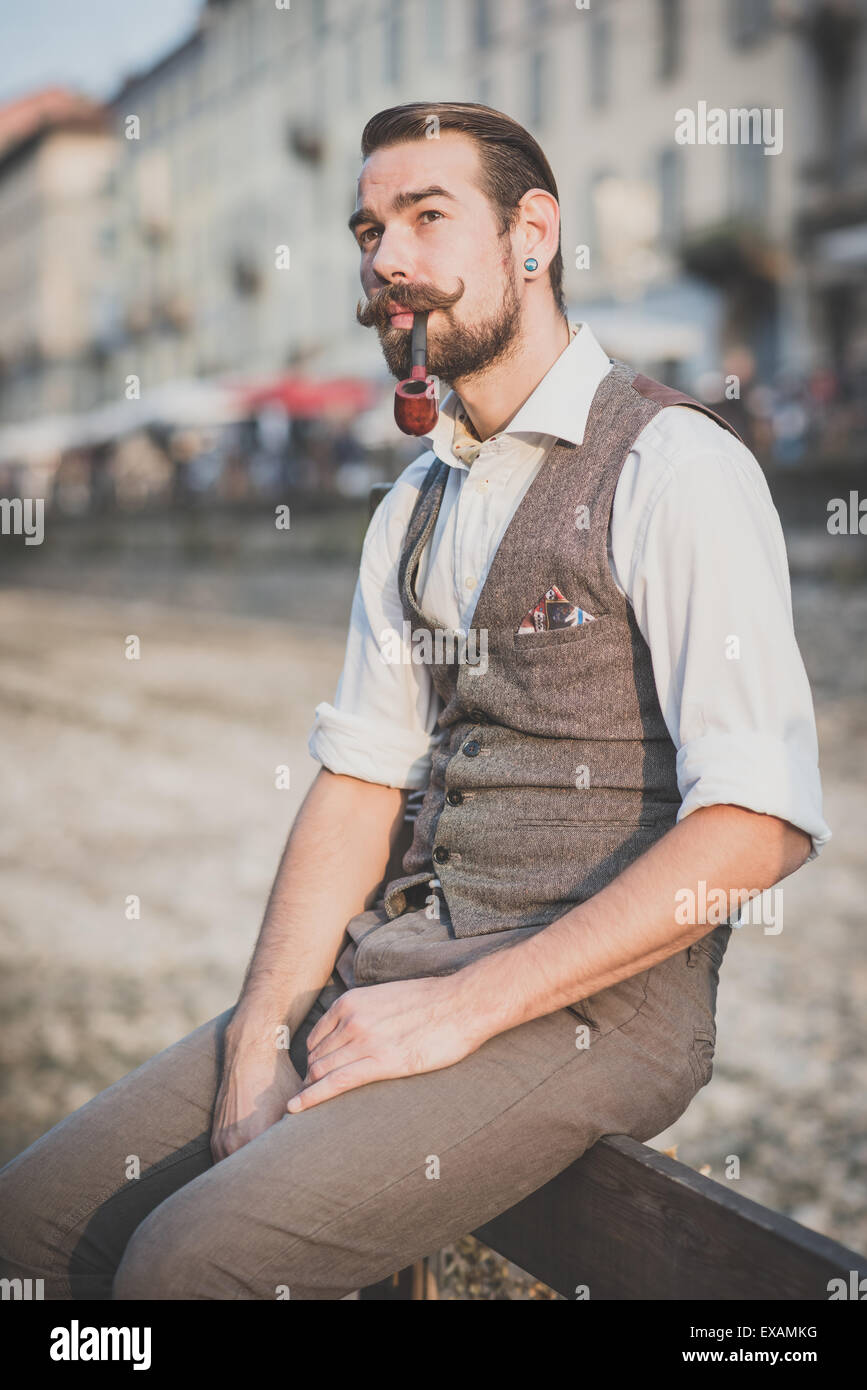 handsome big moustache hipster man smoking pipe in the city Stock Photo ...