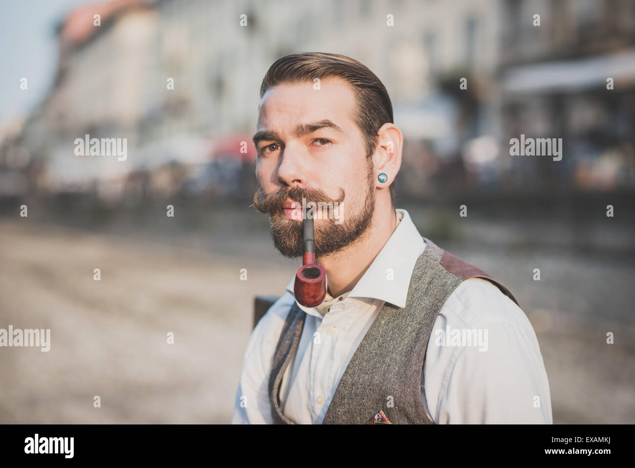 handsome big moustache hipster man smoking pipe in the city Stock Photo ...
