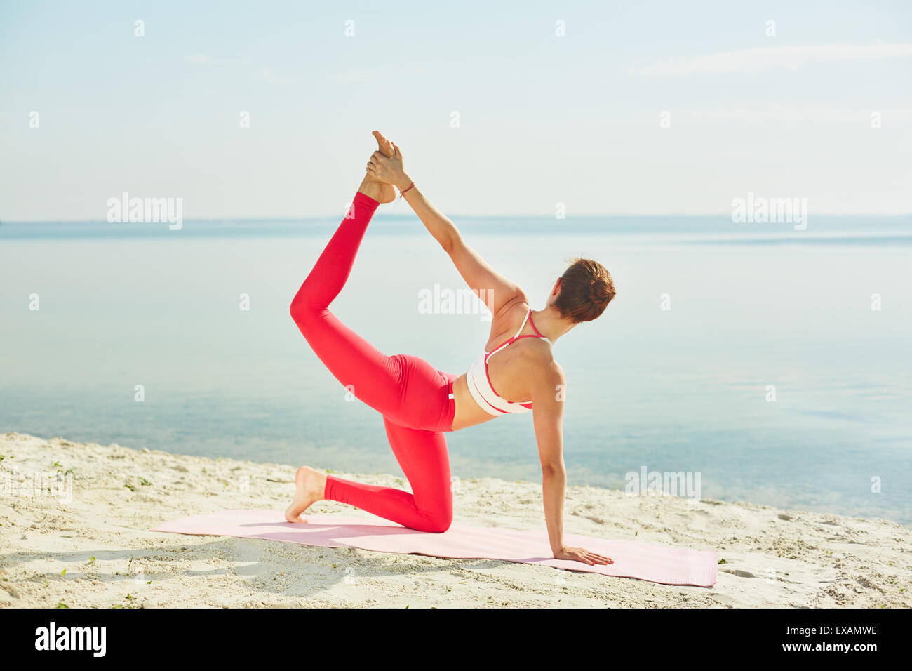 Sporty female in activewear doing exercise for stretching and keeping balance Stock Photo - Alamy