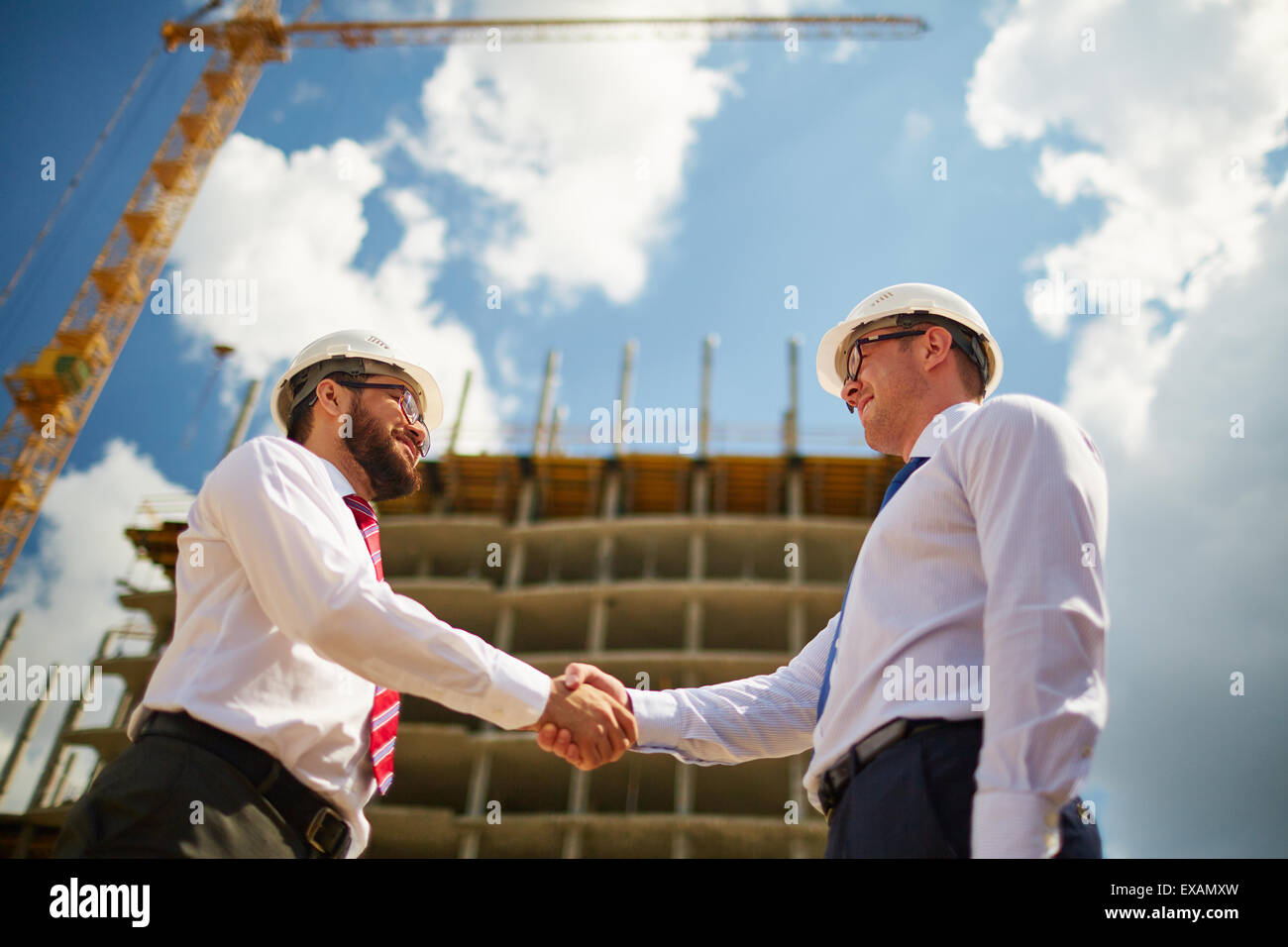 Two handsome architects approving deal by handshake Stock Photo - Alamy