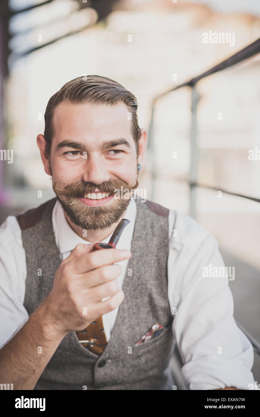 handsome big moustache hipster man smoking pipe in the city Stock Photo ...