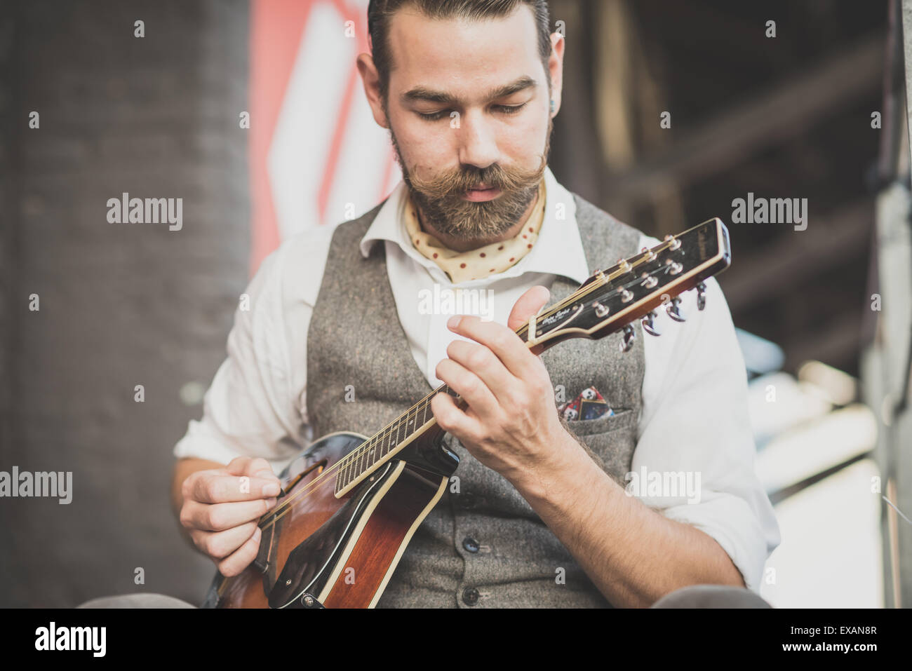 handsome big moustache hipster man playing mandolin in the city Stock ...