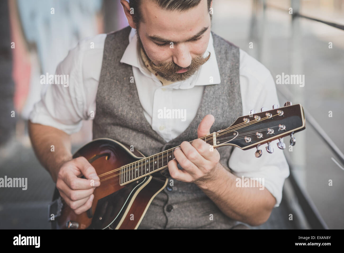 handsome big moustache hipster man playing mandolin in the city Stock ...