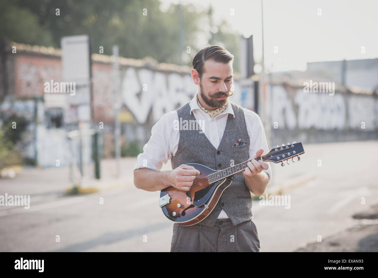 handsome big moustache hipster man playing mandolin in the city Stock ...