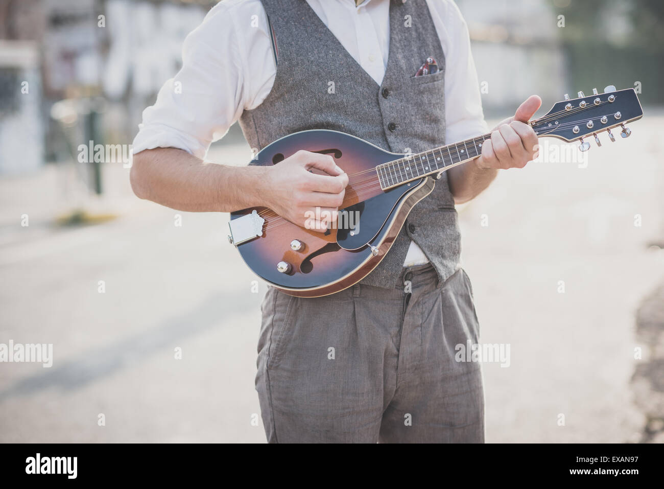 handsome big moustache hipster man playing mandolin in the city Stock ...