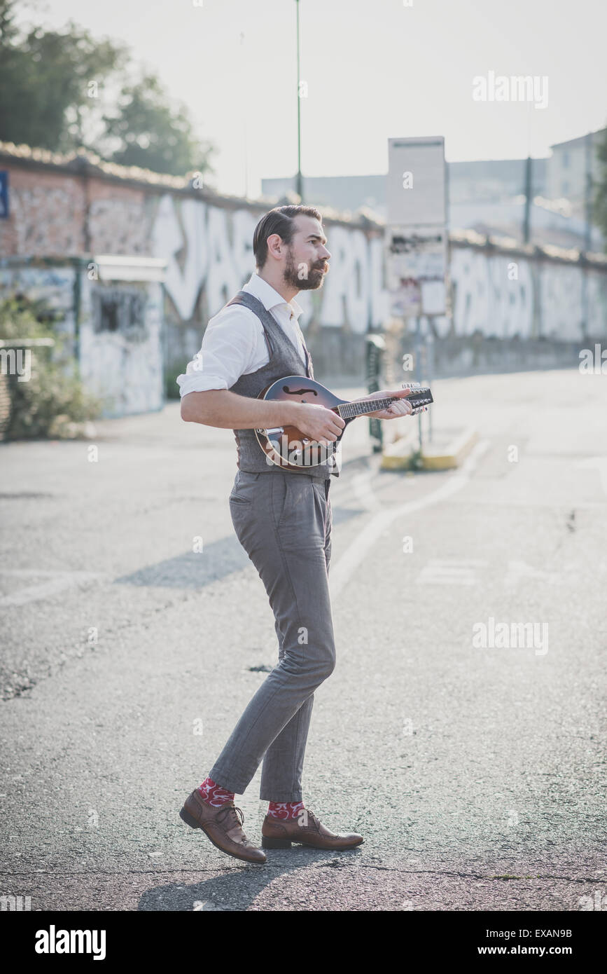 handsome big moustache hipster man playing mandolin in the city Stock ...