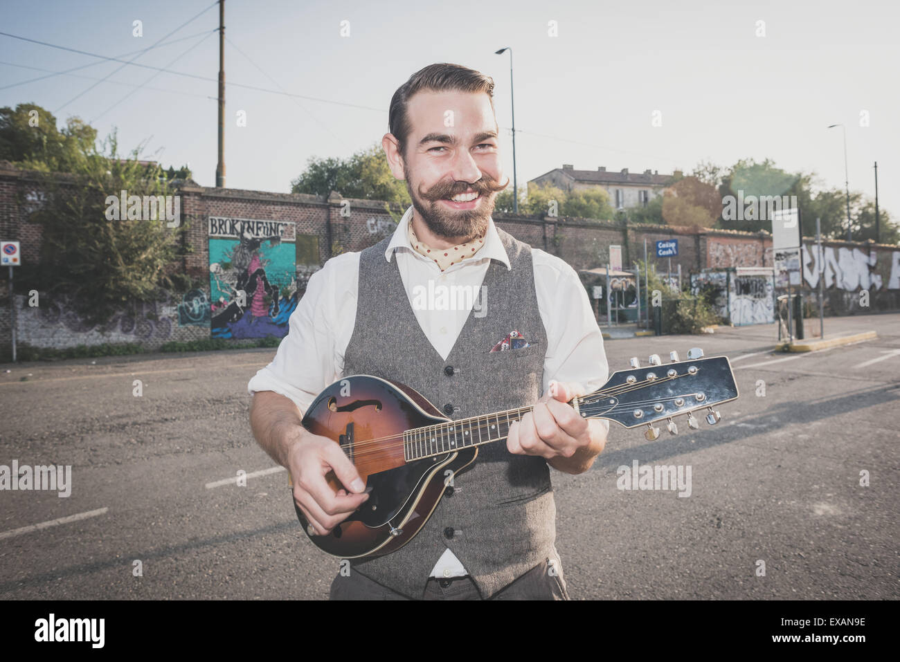 handsome big moustache hipster man playing mandolin in the city Stock ...