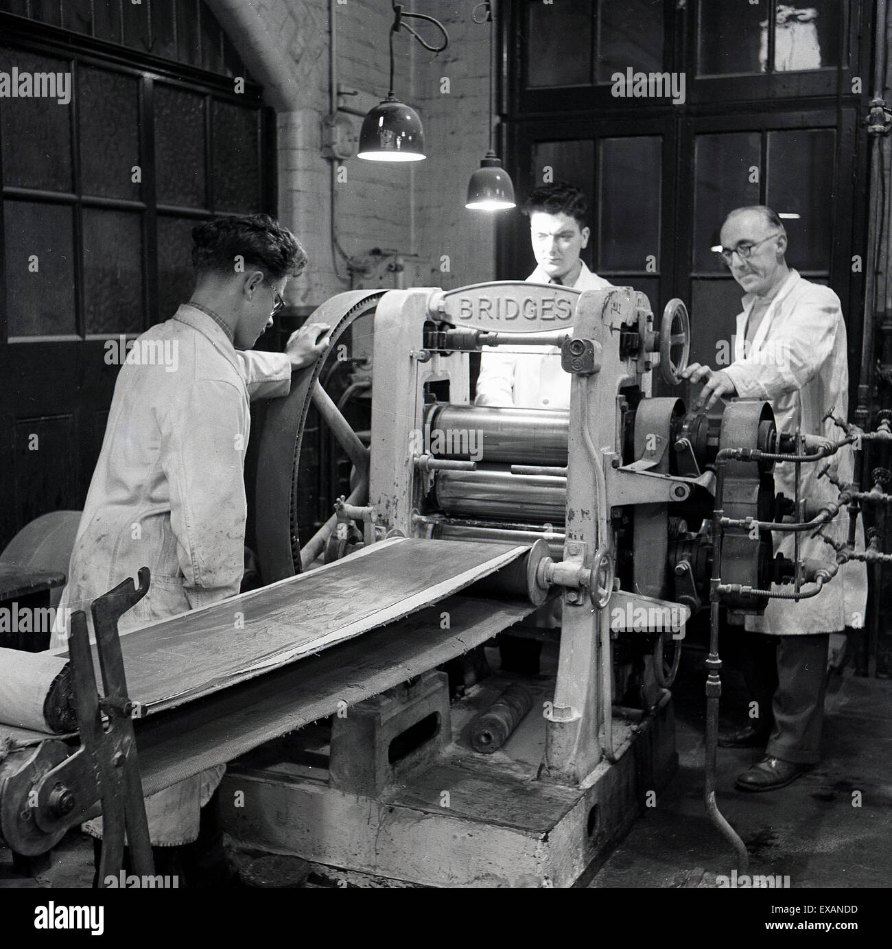 1950s, two young male engineering apprentices with instructor Stock ...