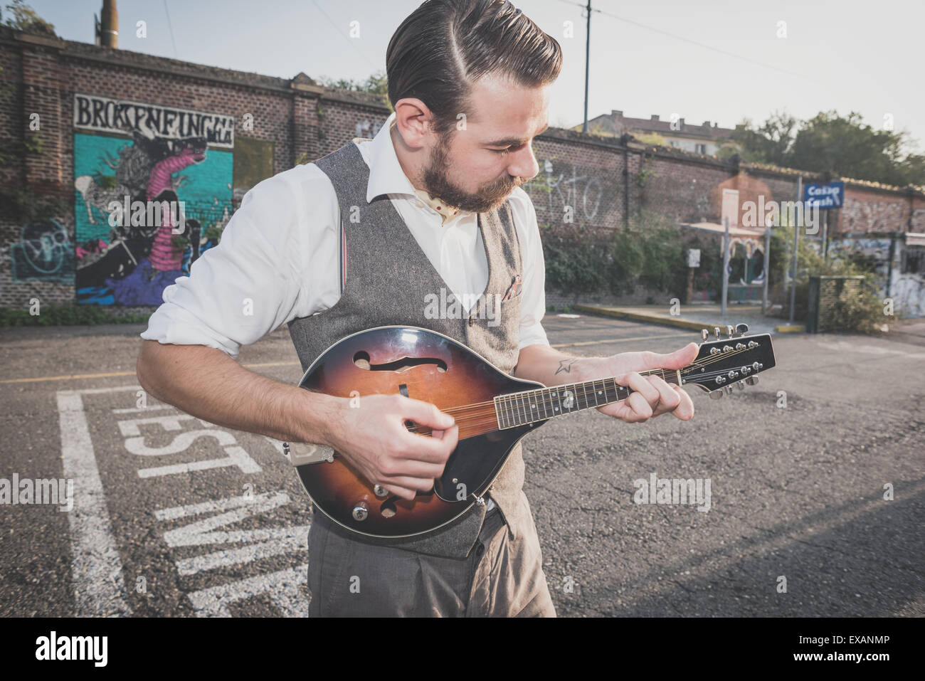 handsome big moustache hipster man playing mandolin in the city Stock ...