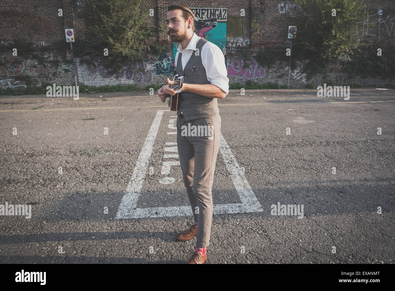 handsome big moustache hipster man playing mandolin in the city Stock ...