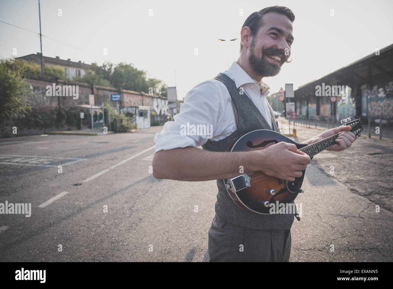 handsome big moustache hipster man playing mandolin in the city Stock ...