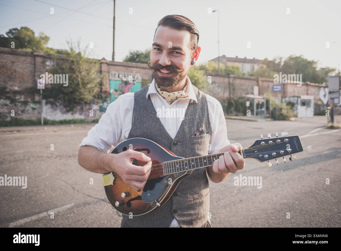 handsome big moustache hipster man playing mandolin in the city Stock ...