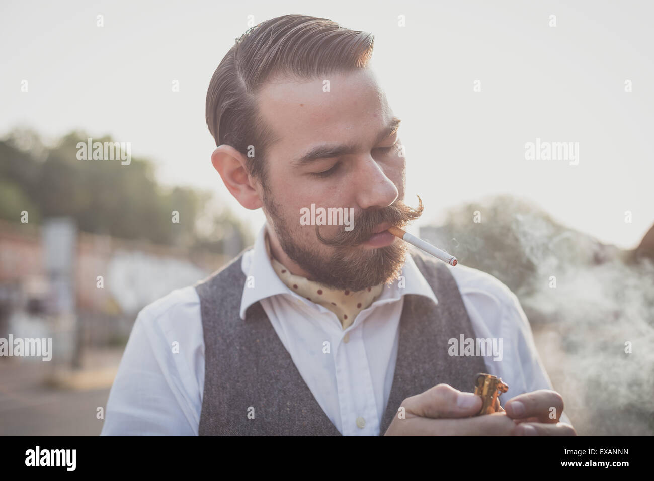 handsome big moustache hipster man smoking cigarette in the city Stock ...