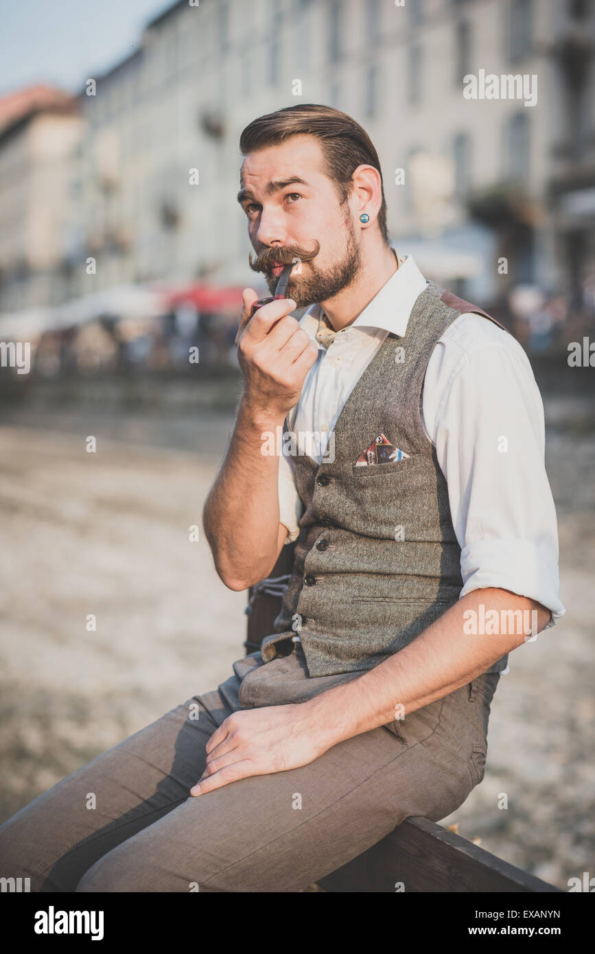 handsome big moustache hipster man smoking pipe in the city Stock Photo ...