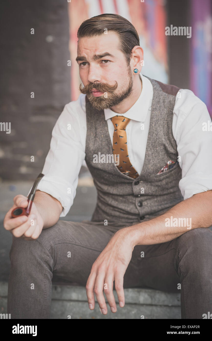 handsome big moustache hipster man smoking pipe in the city Stock Photo ...