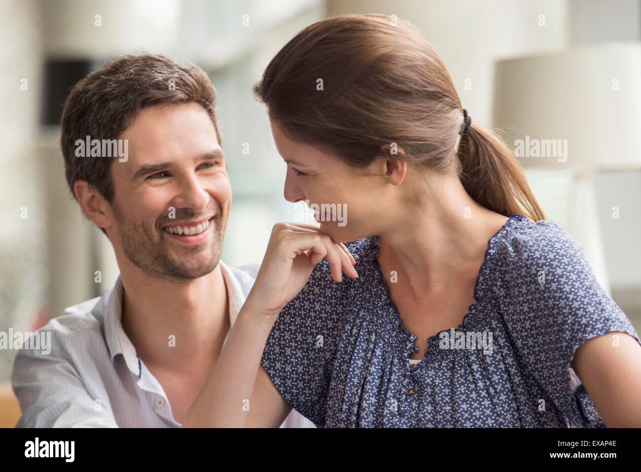 Couple smiling together at home Stock Photo - Alamy