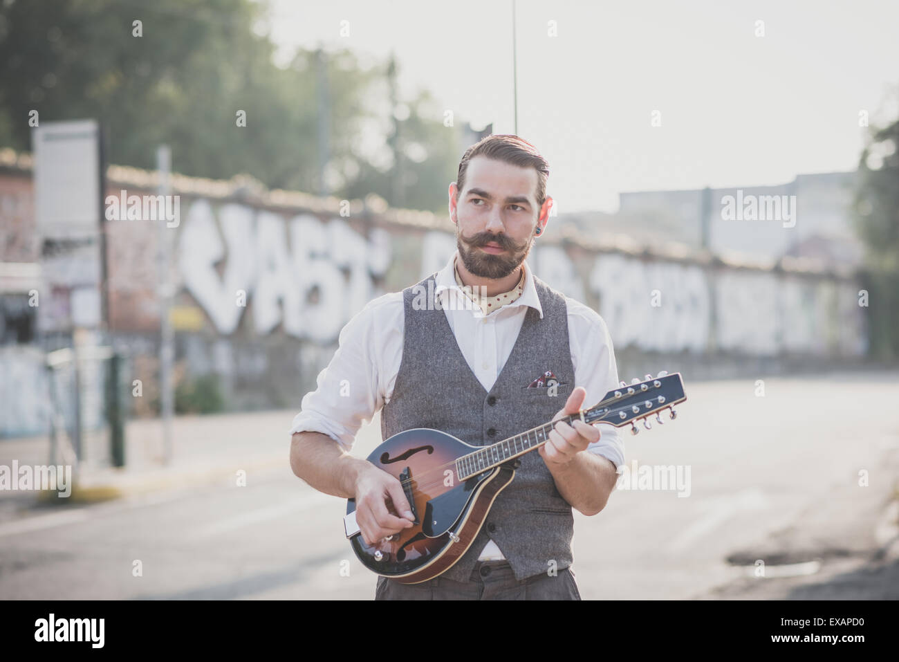 handsome big moustache hipster man playing mandolin in the city Stock ...